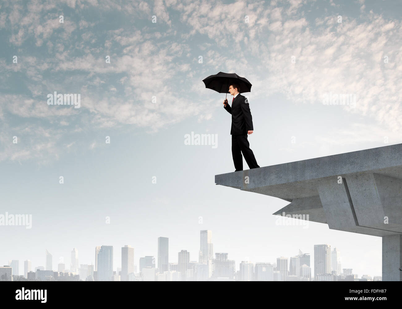 Image of businessman with umbrella standing at the edge of bridge Stock ...