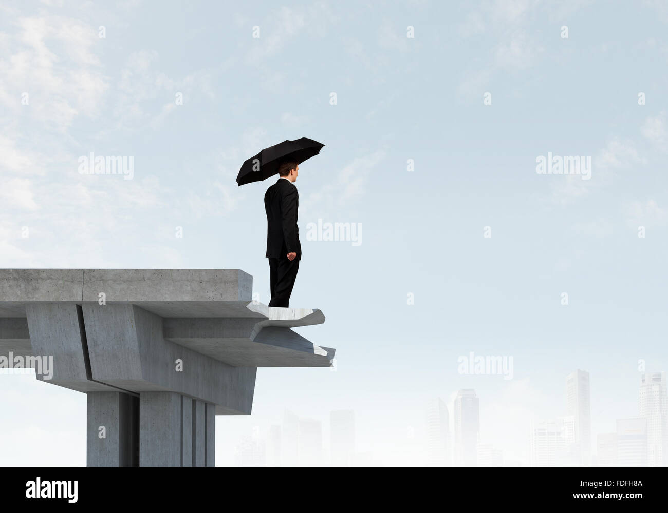 Image of businessman with umbrella standing at the edge of bridge Stock ...
