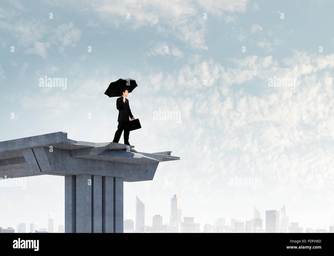 Image of businessman with umbrella standing at the edge of bridge Stock ...