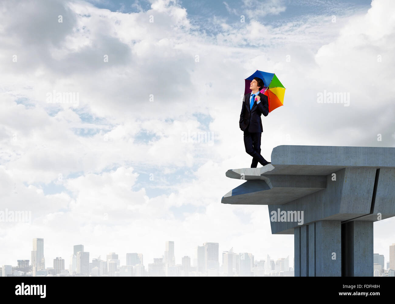 Image of businessman with umbrella standing at the edge of bridge Stock ...