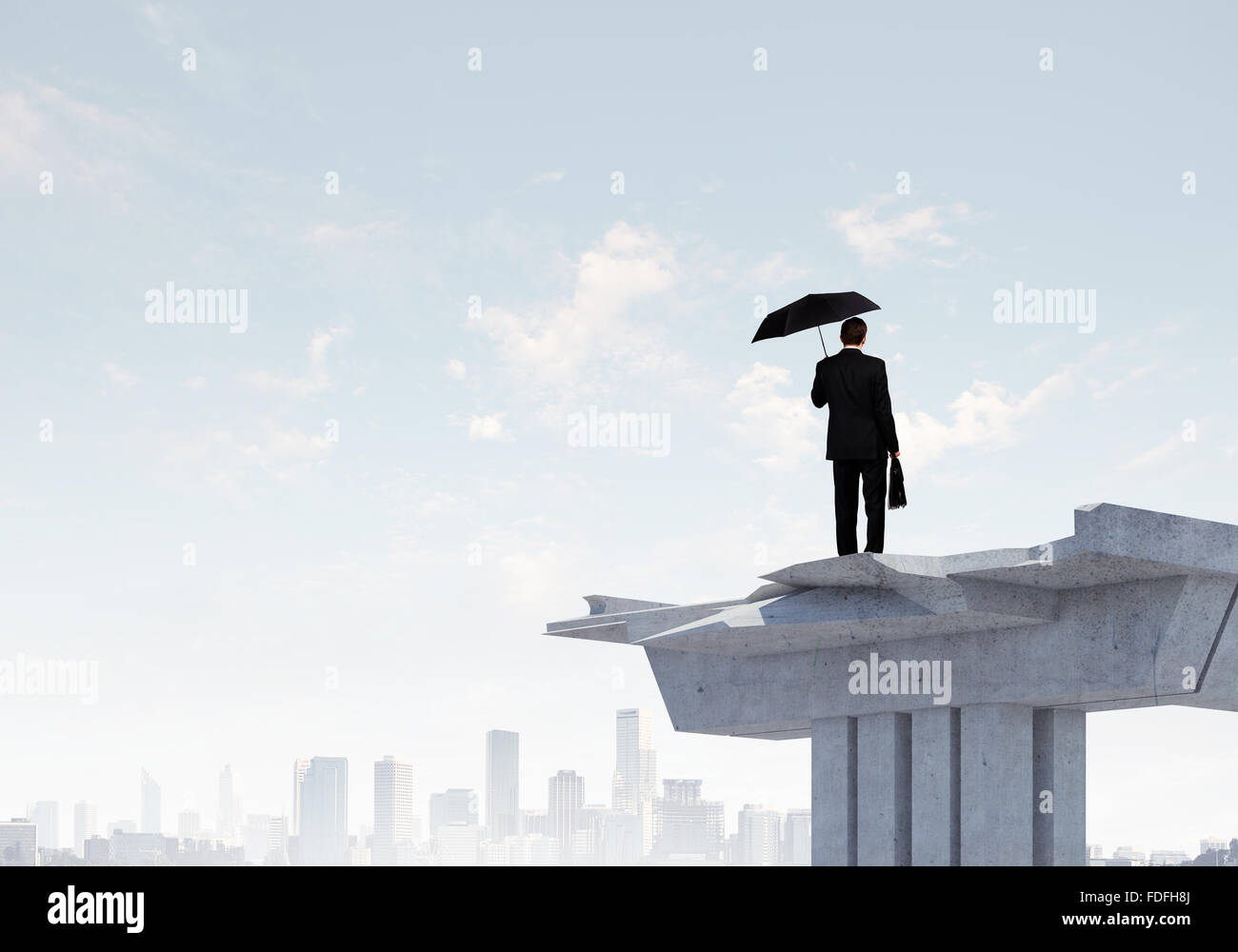 Image of businessman with umbrella standing at the edge of bridge Stock ...