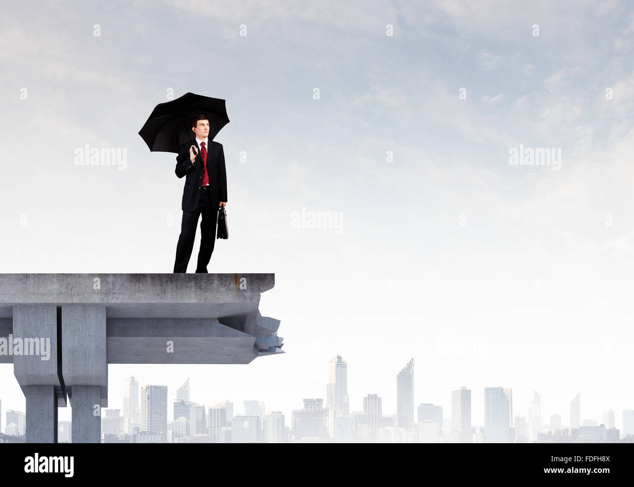 Image of businessman with umbrella standing at the edge of bridge Stock ...