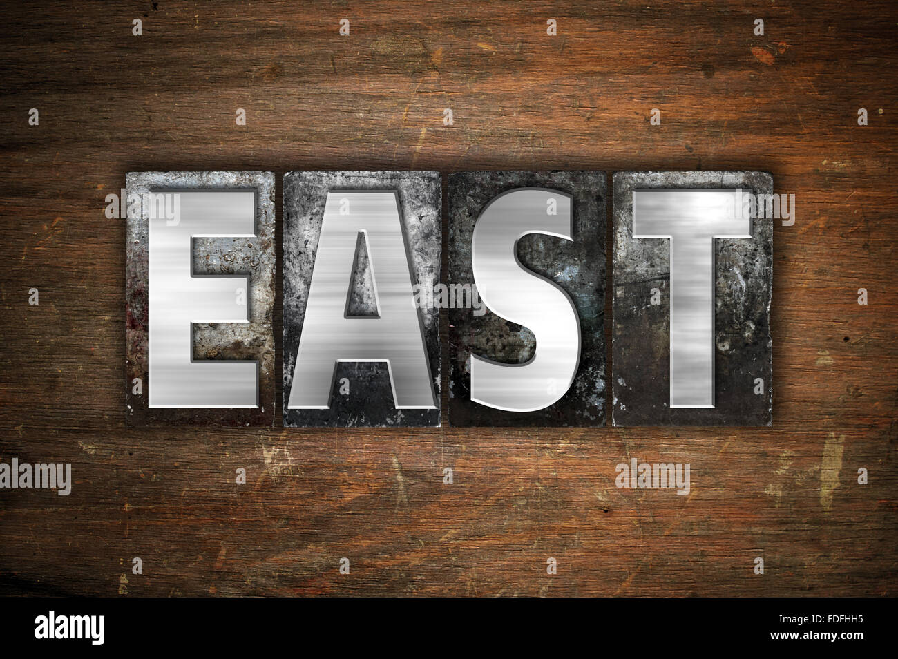 The word "East" written in vintage metal letterpress type on an aged ...