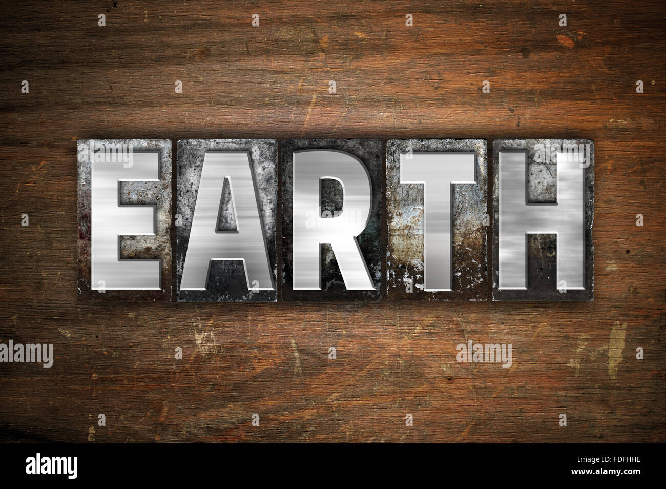 The word "Earth" written in vintage metal letterpress type on an aged ...