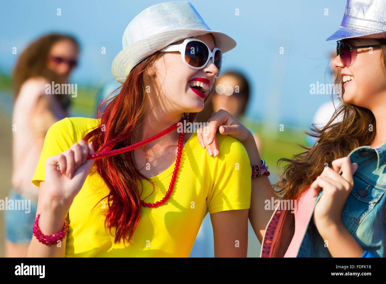 Image of two attractive young women in bright clothes having fun ...