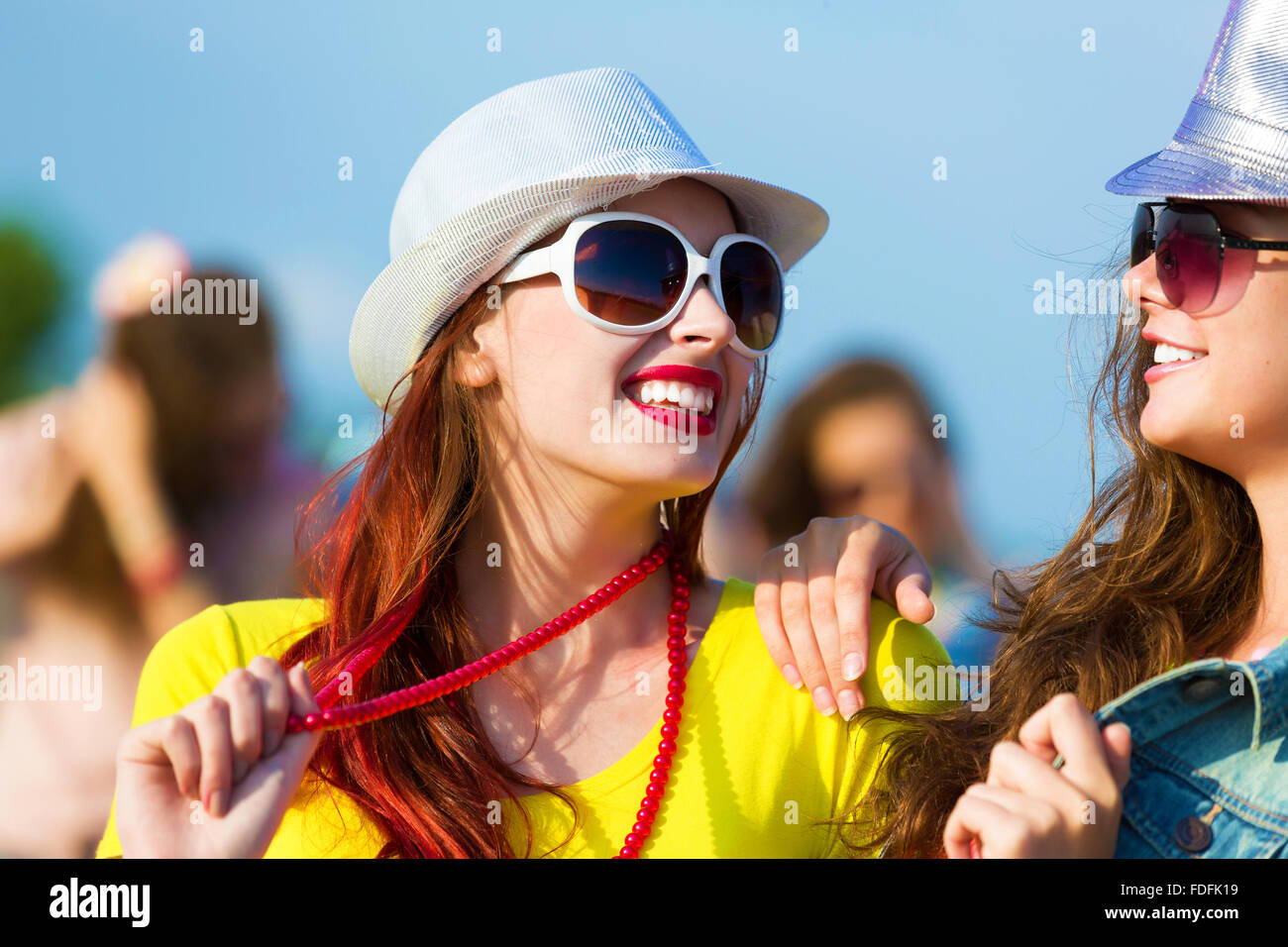 Image of two attractive young women in bright clothes having fun ...