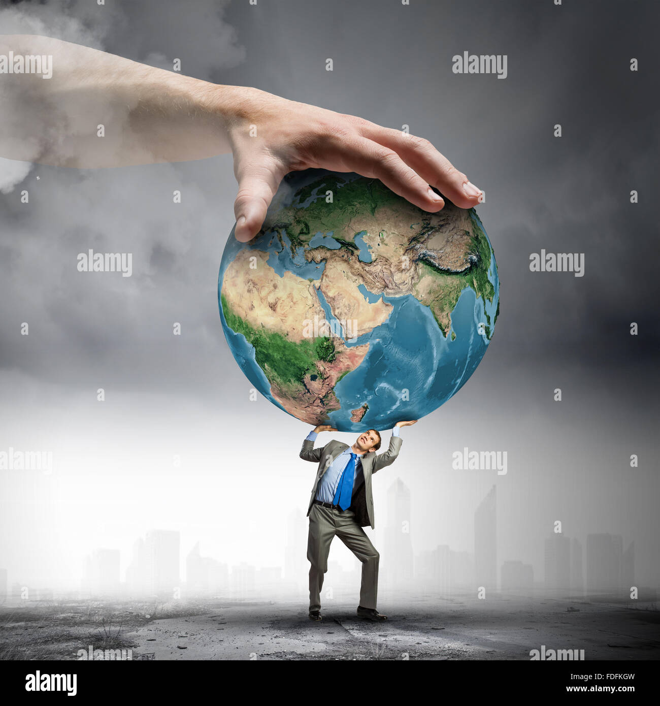 Image of young businessman under pressure of planet Earth. Elements of ...