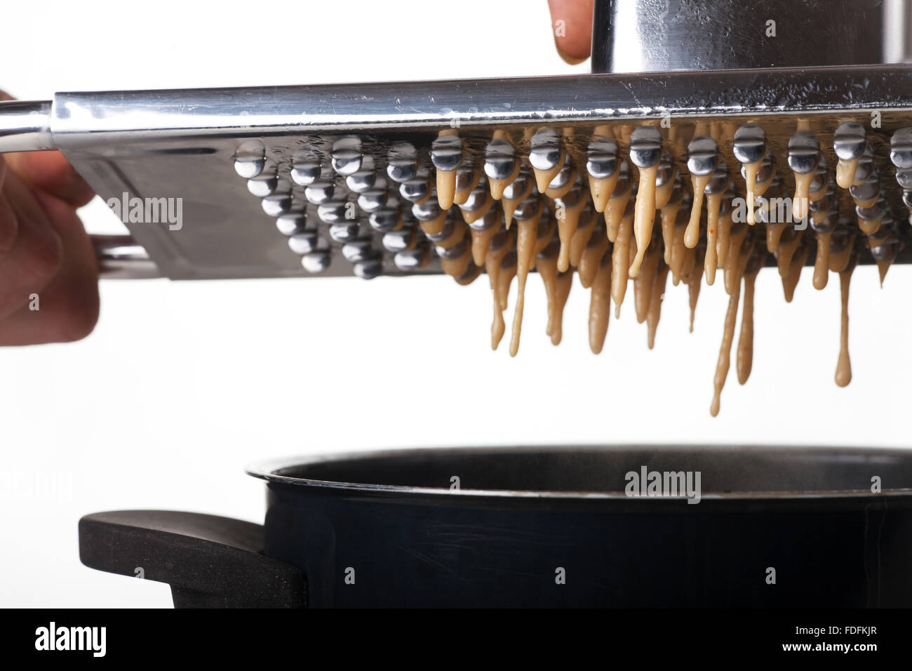 making bavarian spaetzle noodles in a pot Stock Photo - Alamy