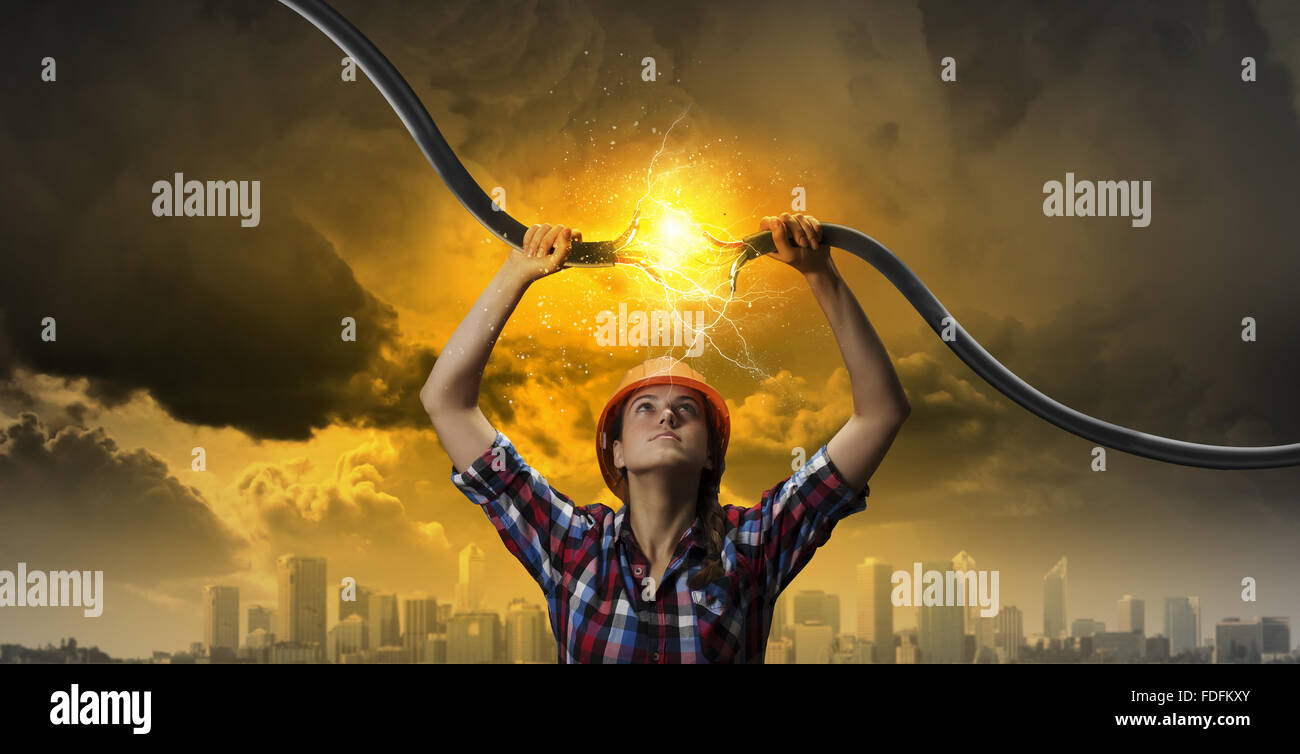 Image of woman holding electricity cable above head Stock Photo - Alamy