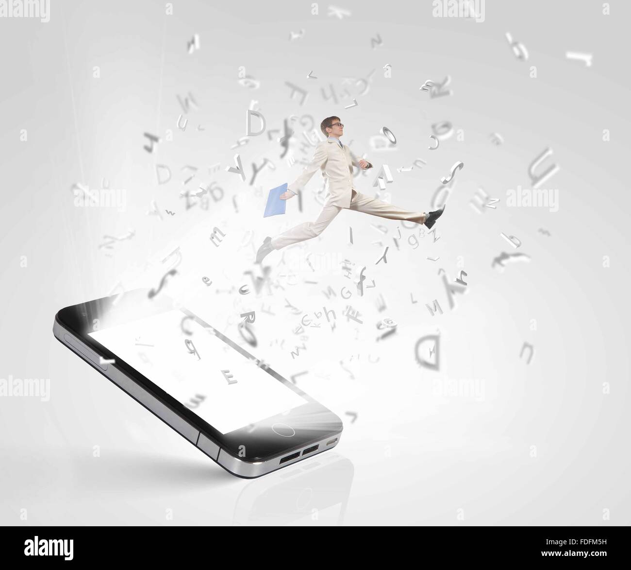 Image of businessman jumping out of mobile phone Stock Photo - Alamy