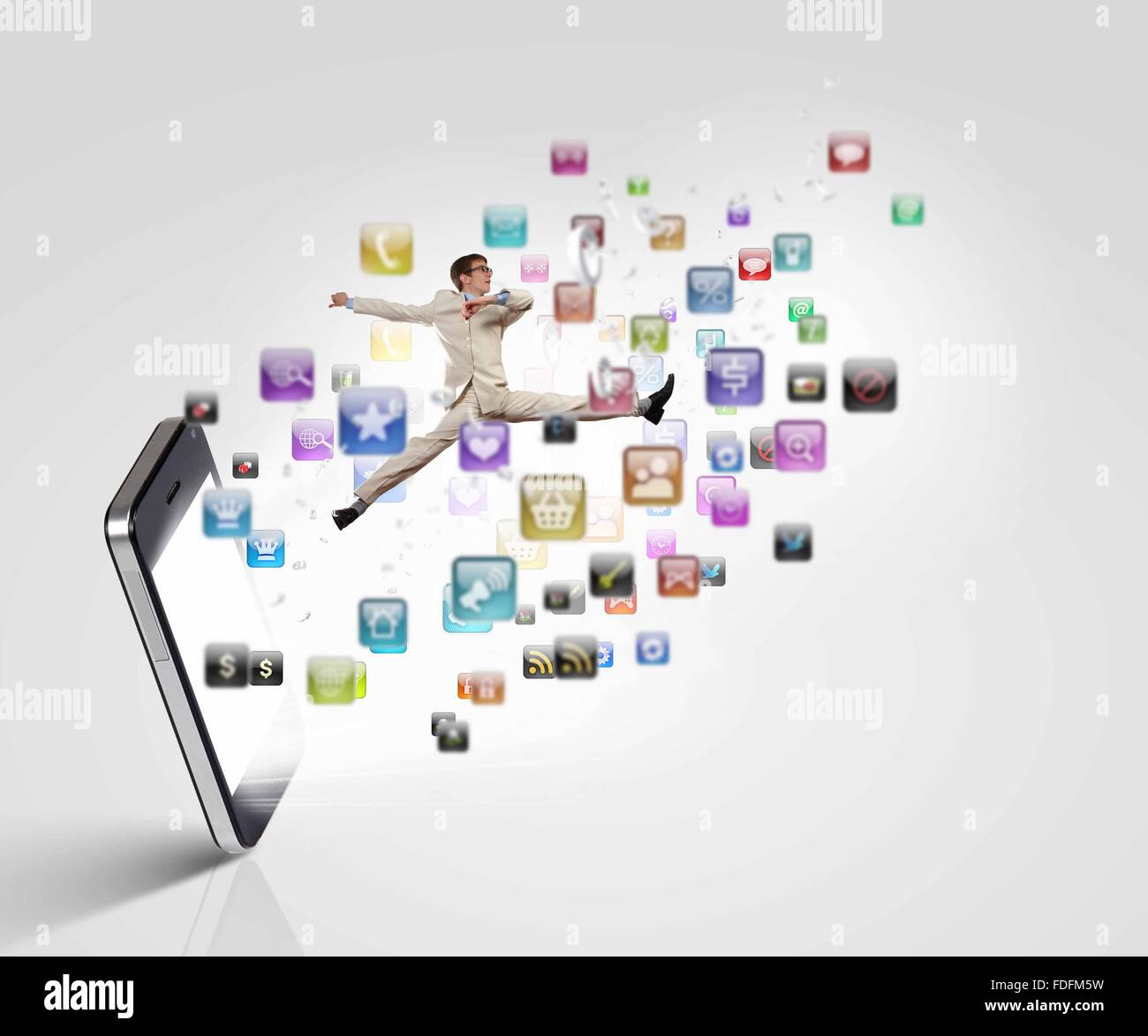 Image of businessman jumping out of mobile phone Stock Photo - Alamy