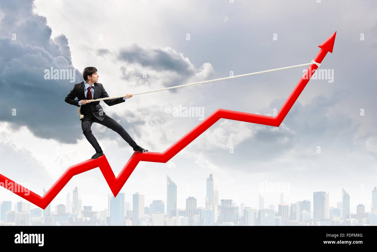 Image of businessman standing on graph and pulling it upwards Stock ...