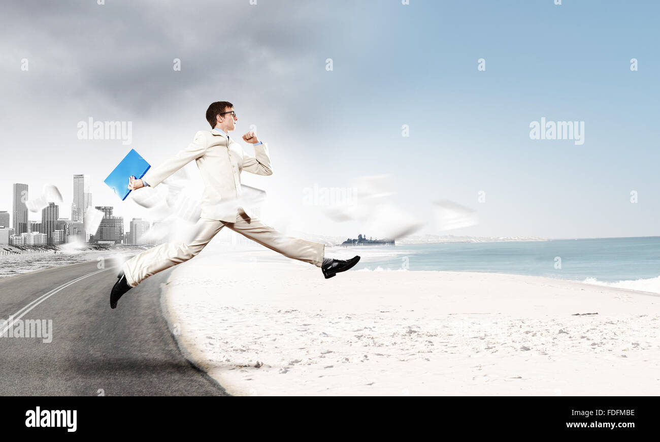 Image of businessman running away from office work Stock Photo - Alamy