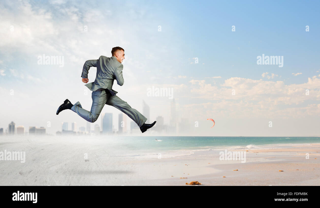 Image of businessman running away from office work Stock Photo - Alamy