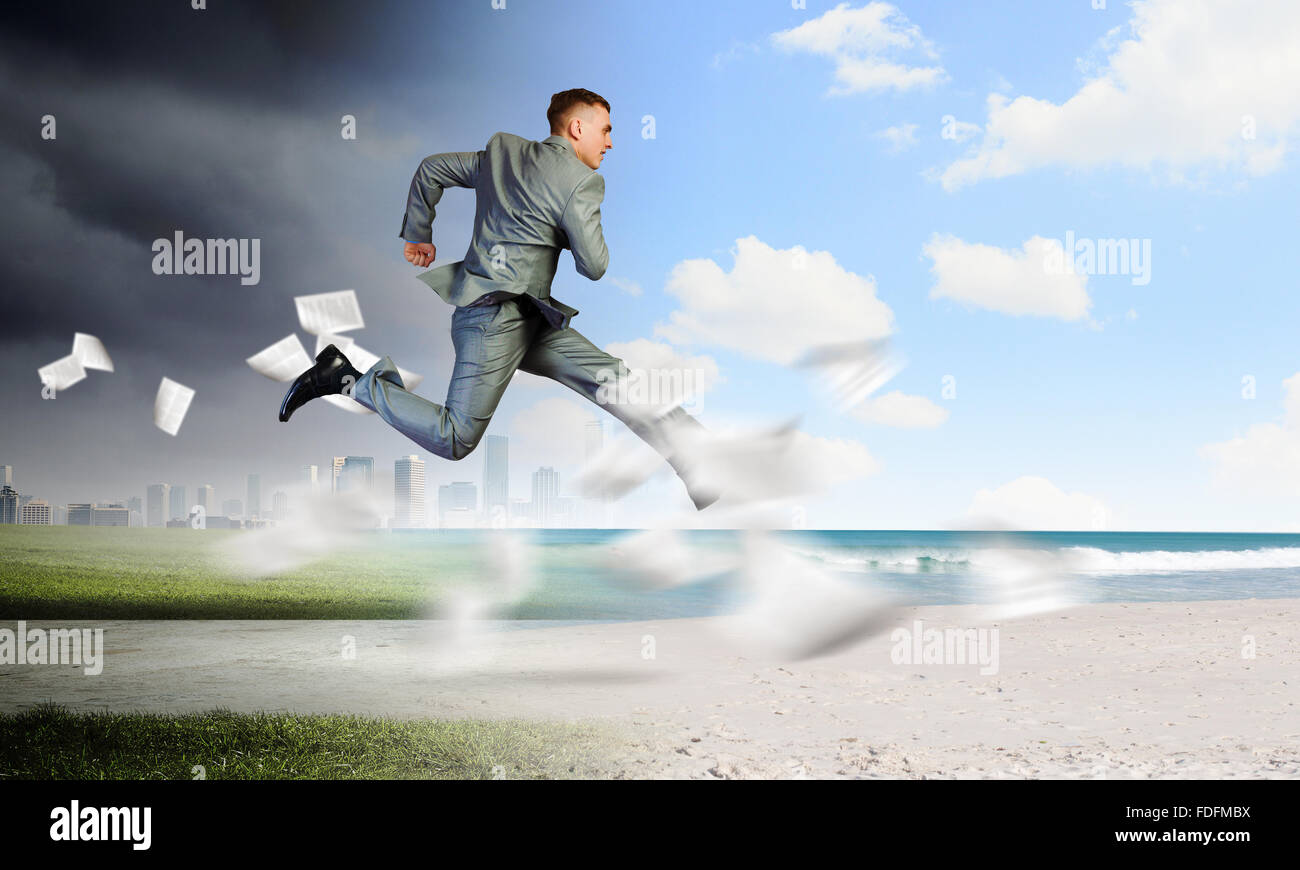 Image of businessman running away from office work Stock Photo - Alamy