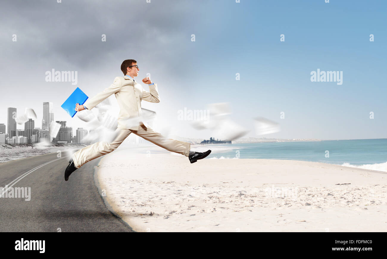 Image of businessman running away from office work Stock Photo - Alamy