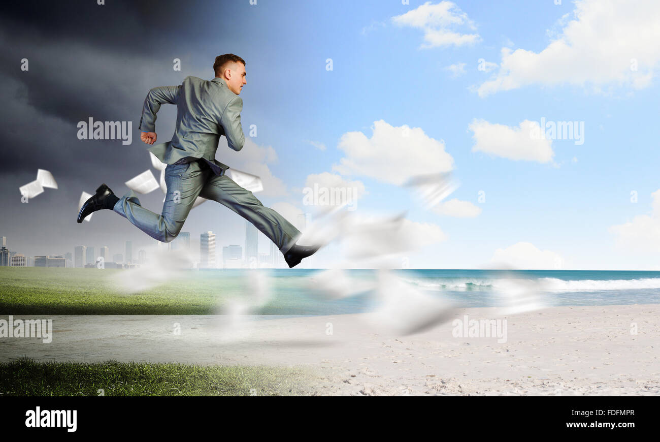 Image of businessman running away from office work Stock Photo - Alamy