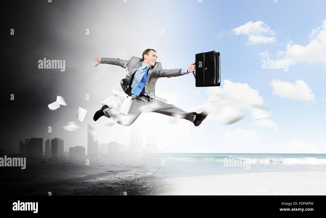 Image of businessman running away from office work Stock Photo - Alamy