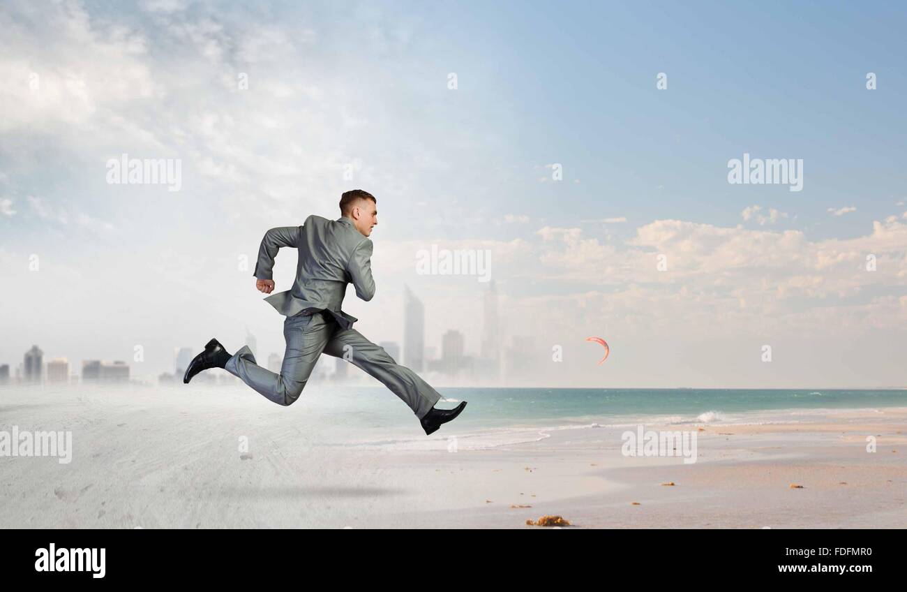 Image of businessman running away from office work Stock Photo - Alamy