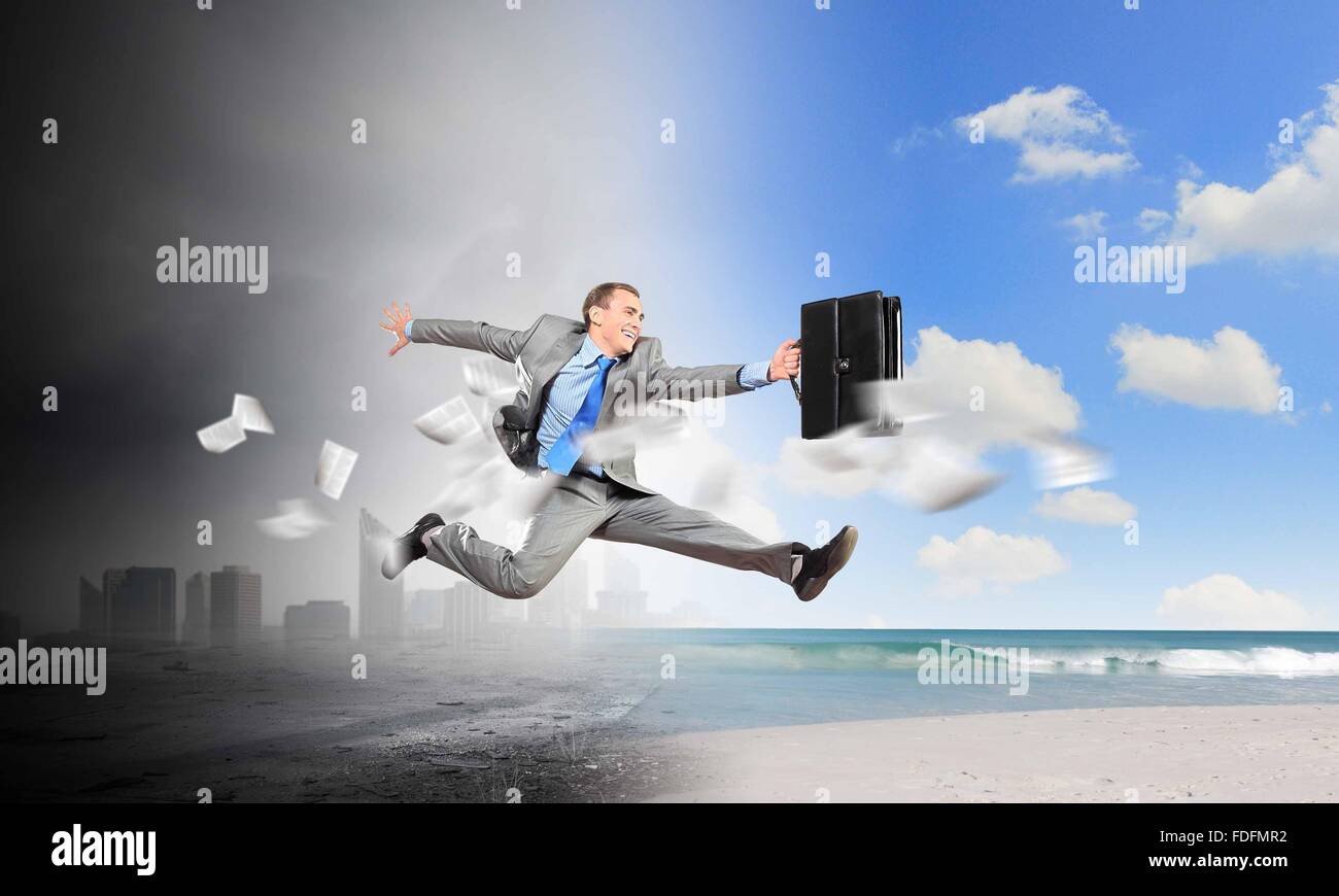 Image of businessman running away from office work Stock Photo - Alamy