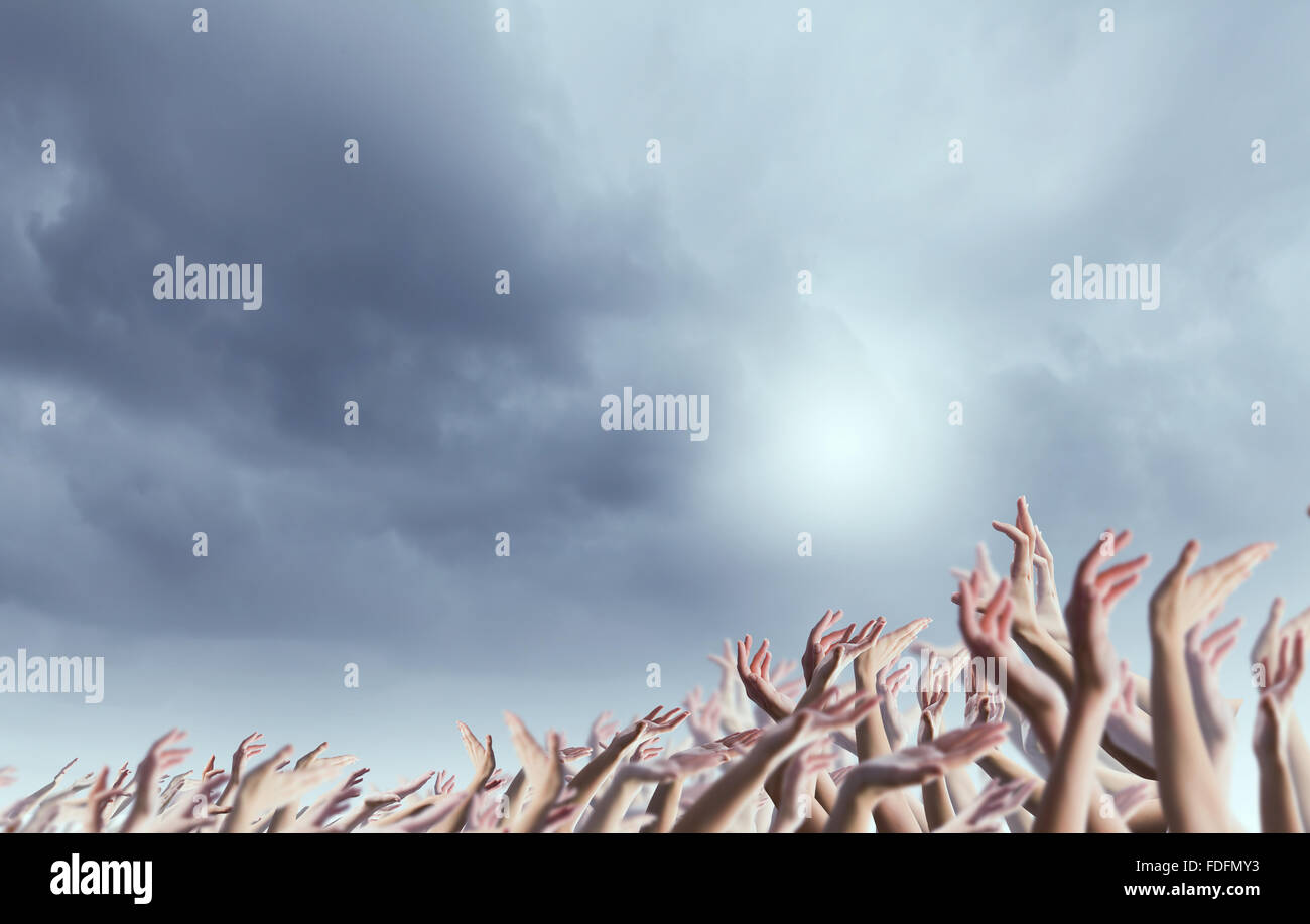 Crowd of people with hands raised up in to sky Stock Photo - Alamy