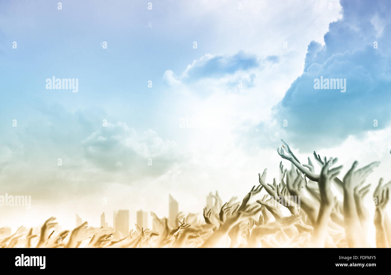 Crowd of people with hands raised up in to sky Stock Photo - Alamy