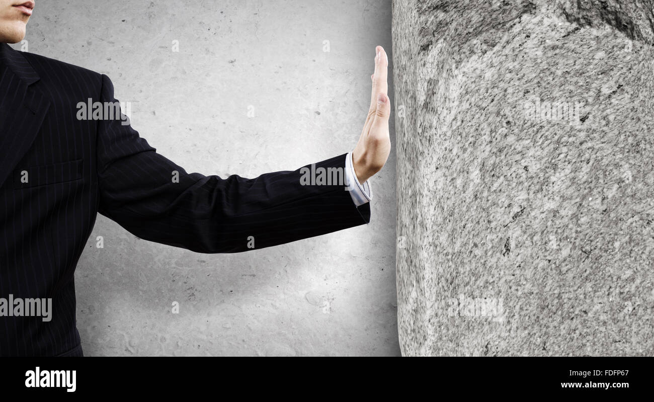 Businessman touching stone grey wall with palm Stock Photo - Alamy