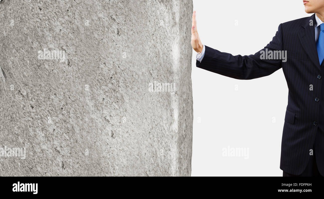 Businessman touching stone grey wall with palm Stock Photo - Alamy