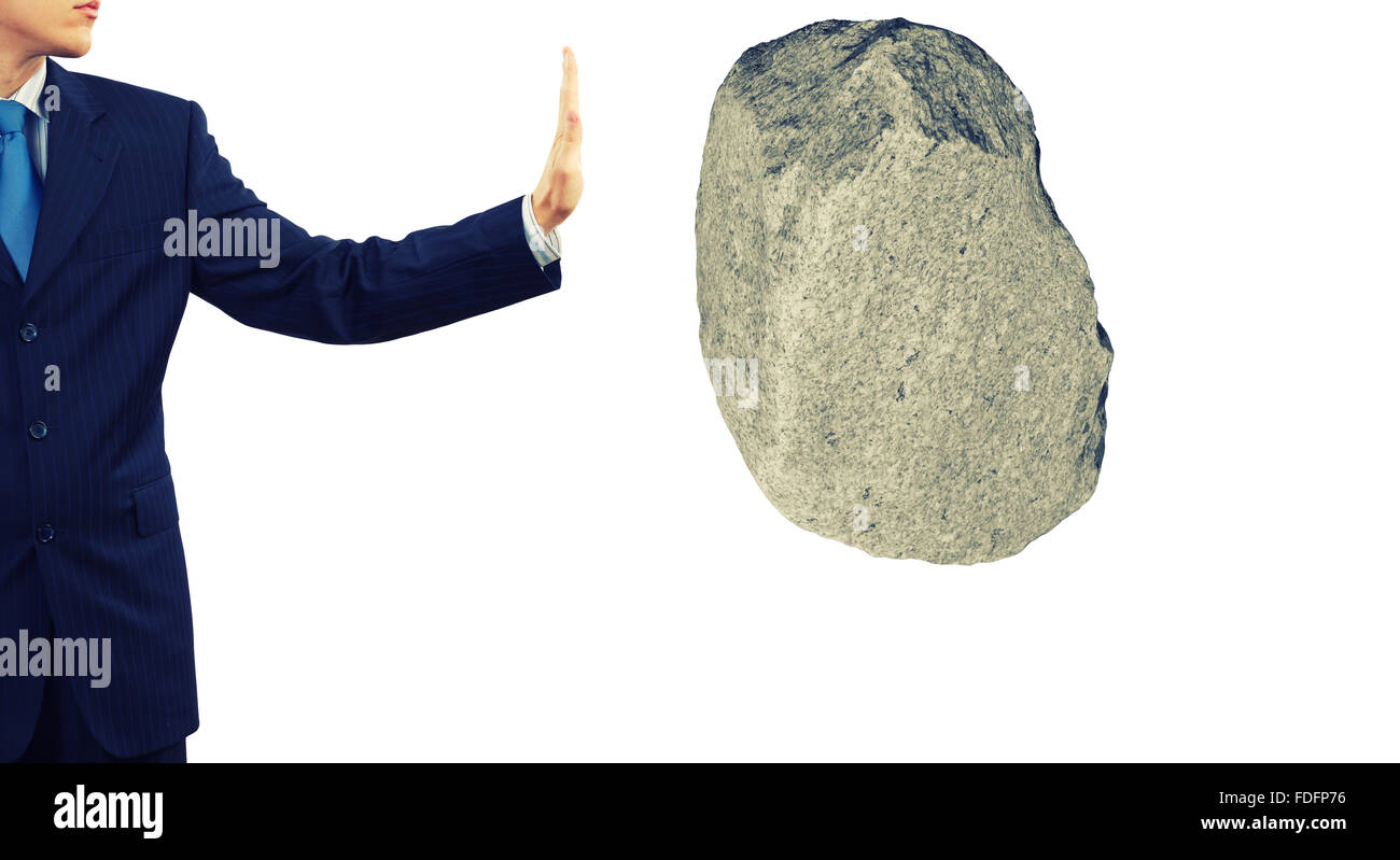 Businessman in suit huge holding stone in palm Stock Photo - Alamy