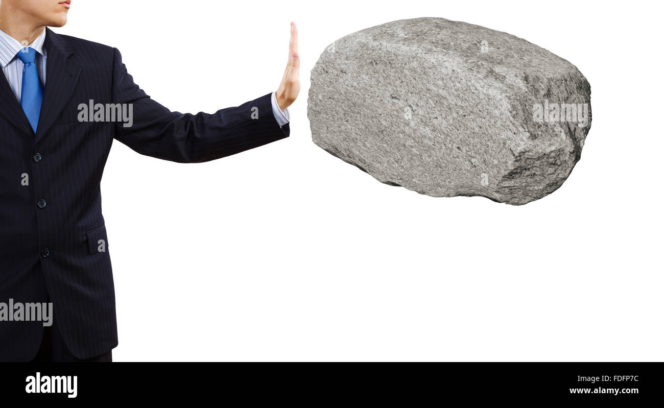 Businessman in suit huge holding stone in palm Stock Photo - Alamy