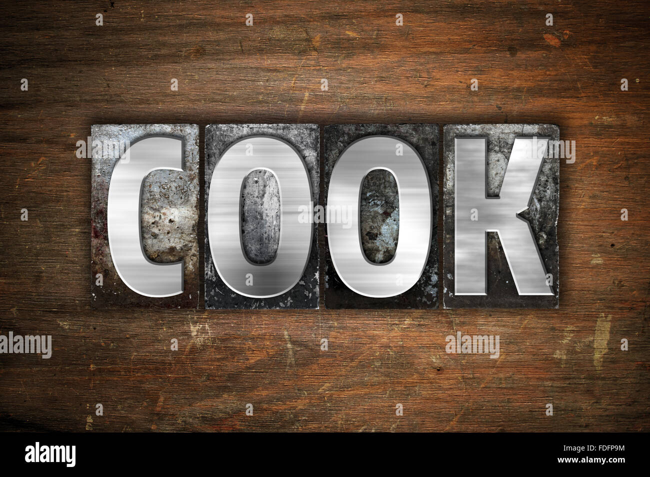 The word "Cook" written in vintage metal letterpress type on an aged ...