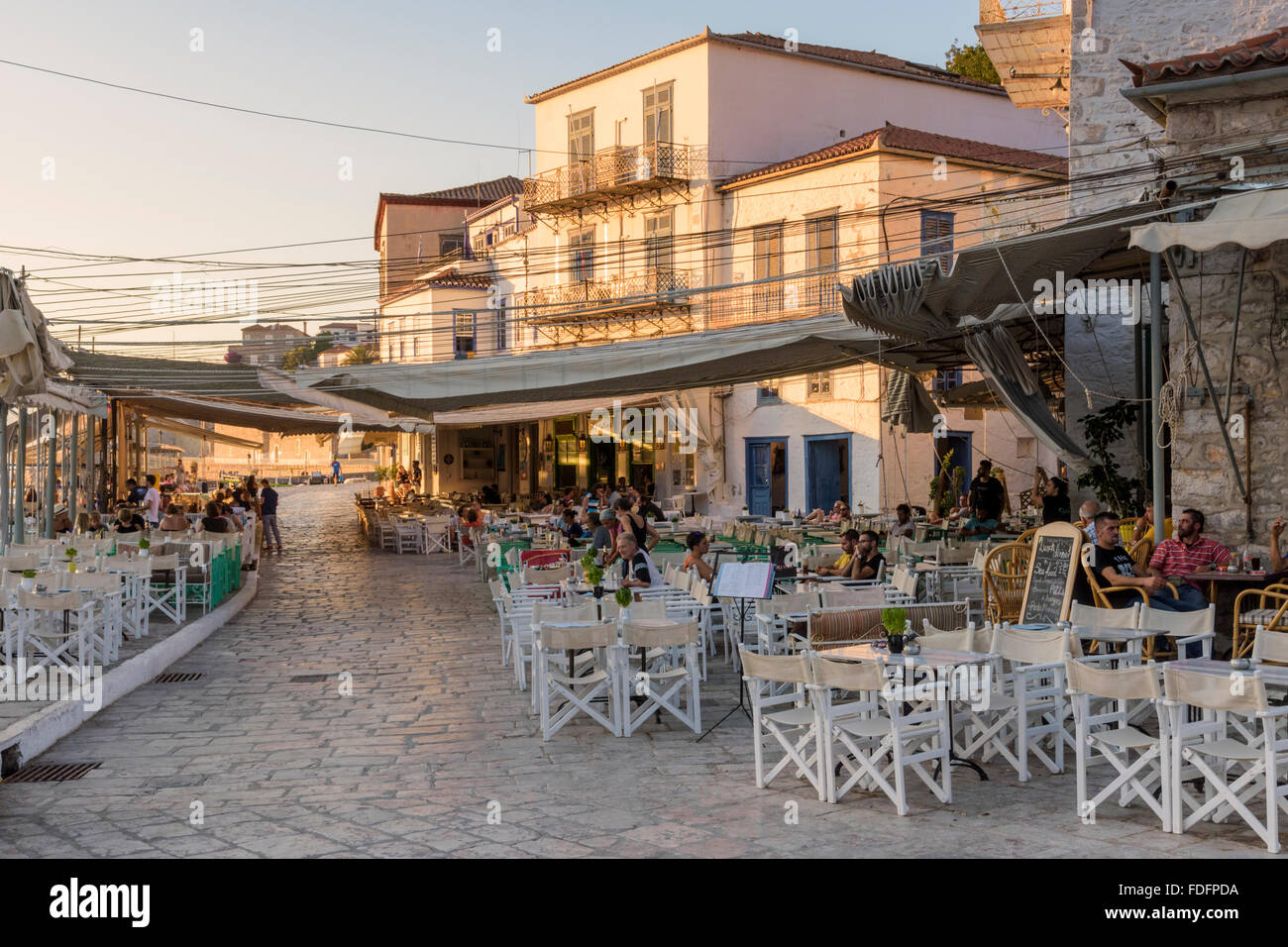 Cafe life in Hydra Town at sunset, Hydra Island, Attica, Greece Stock ...