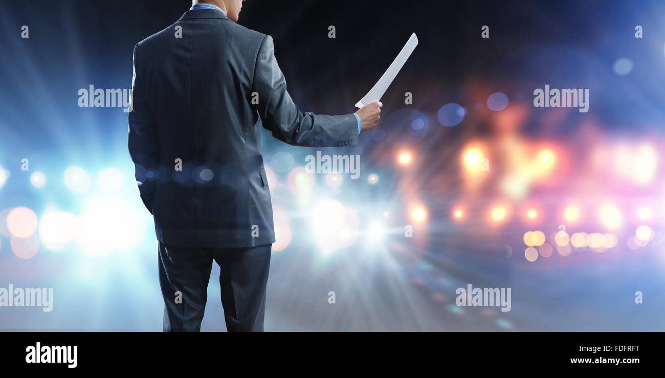 Back view of businessman speaker standing on podium in lights Stock ...