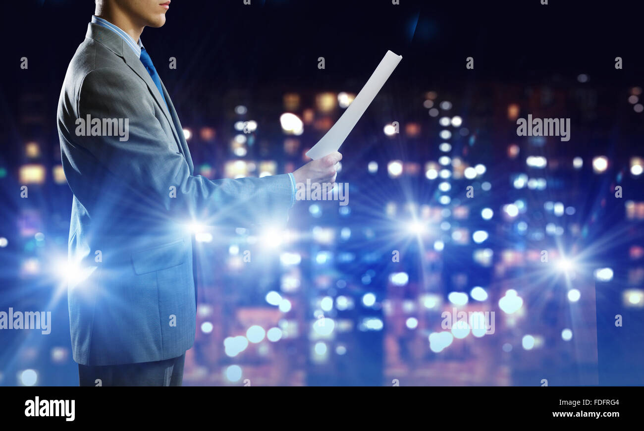 Back view of businessman speaker standing on podium in lights Stock ...
