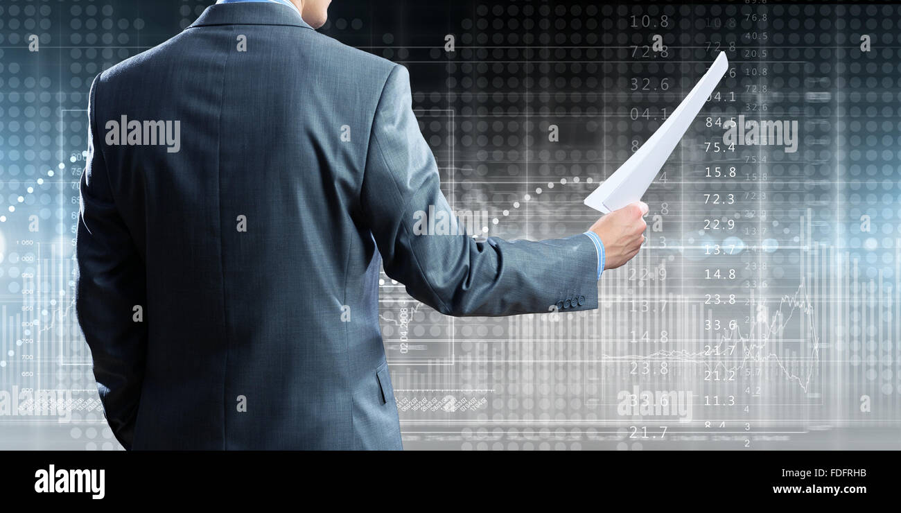 Back view of businessman speaker standing on podium in lights Stock ...