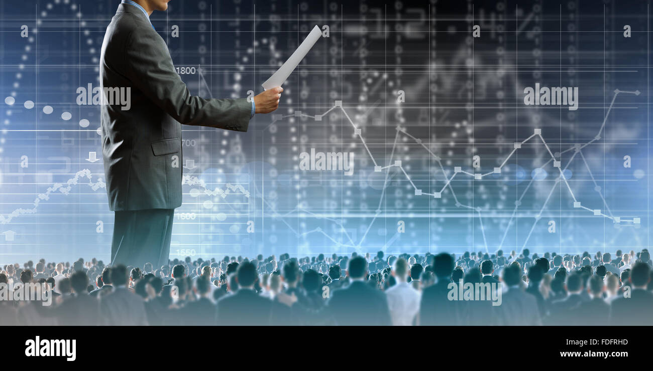 Back view of businessman speaker standing on podium in lights Stock ...