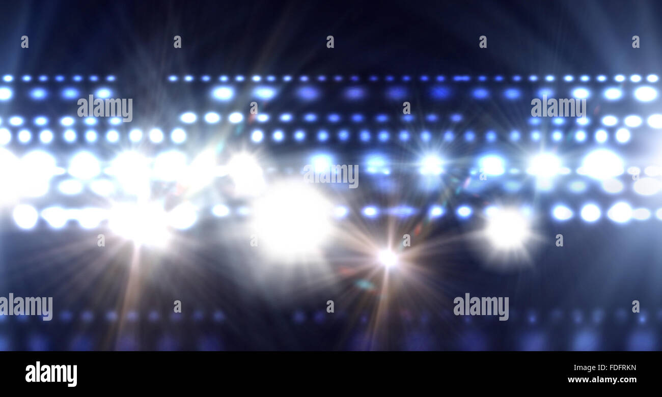 Crowd of businesspeople standing with back with lights at background ...