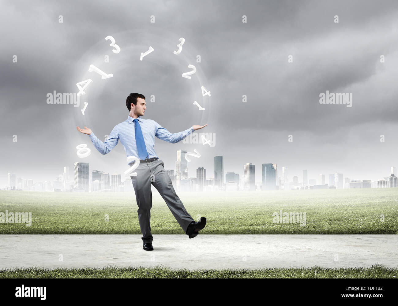 Young businessman juggling with numerals against city background Stock ...