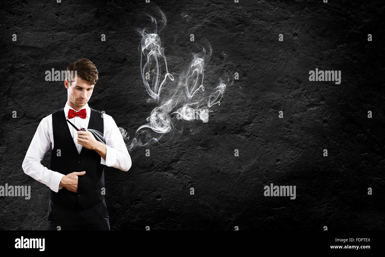 Young handsome businessman in fumes smoking pipe Stock Photo - Alamy