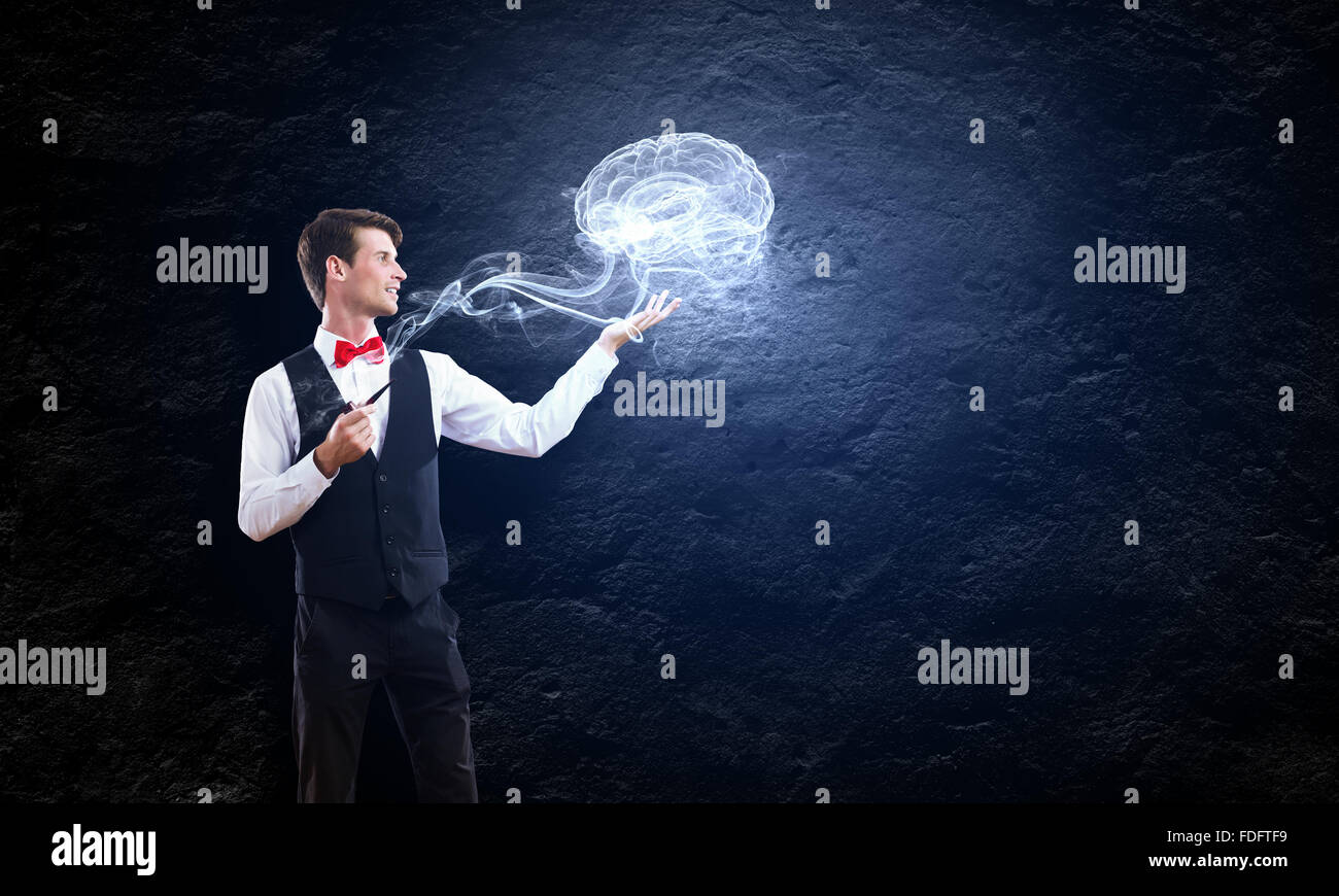 Conceptual image of young handsome man smoking pipe Stock Photo - Alamy