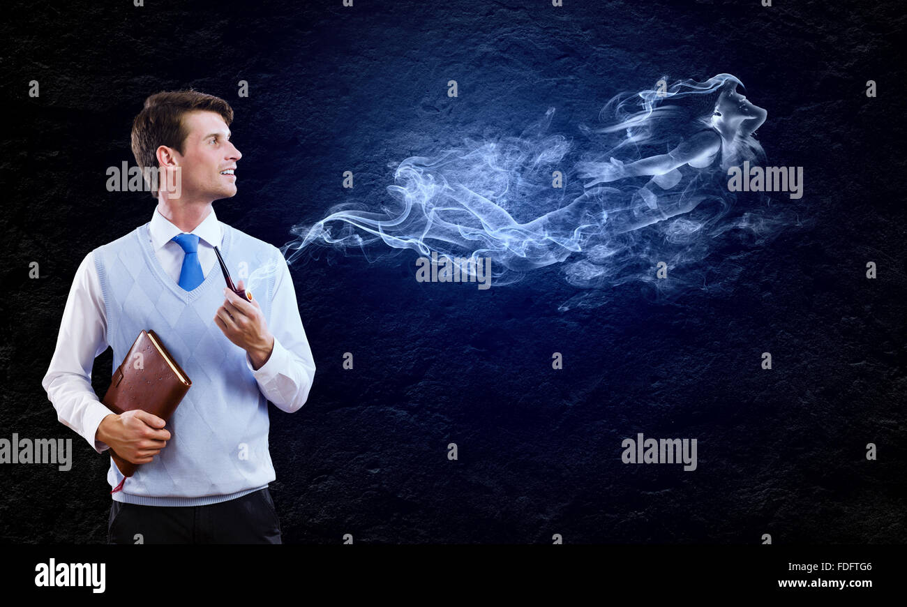 Young handsome businessman smoking pipe against black background Stock ...