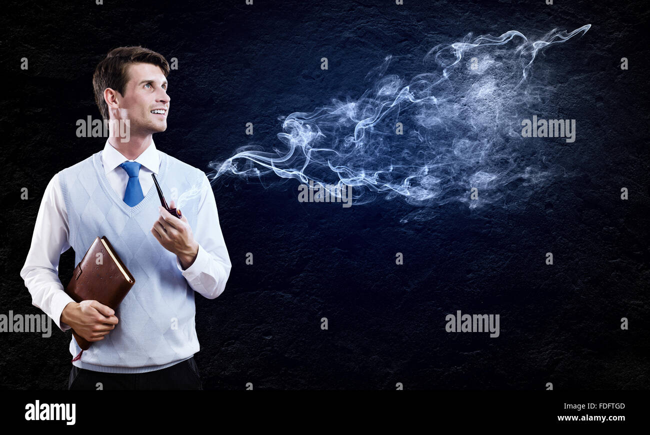 Young handsome businessman smoking pipe against black background Stock ...