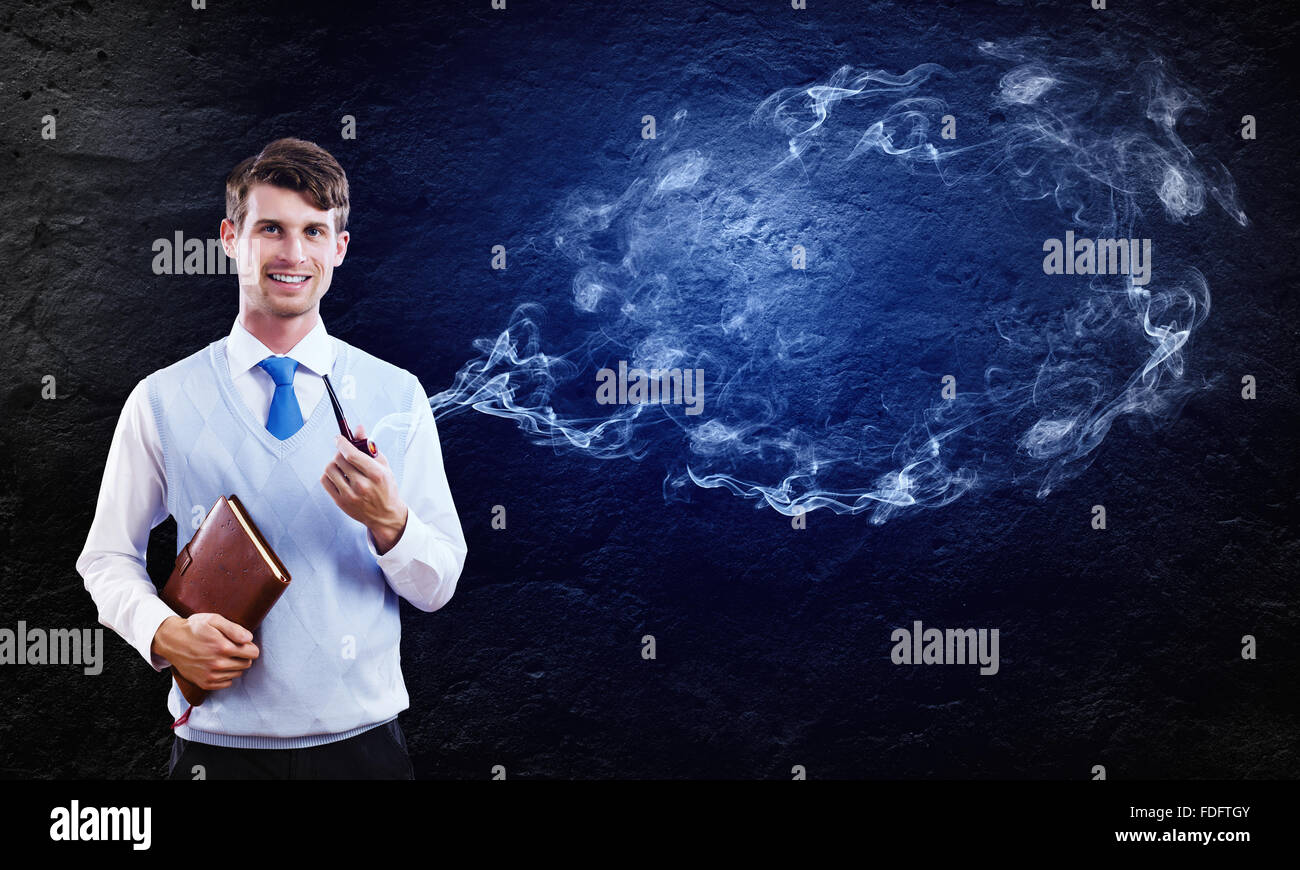 Young handsome businessman smoking pipe against black background Stock ...