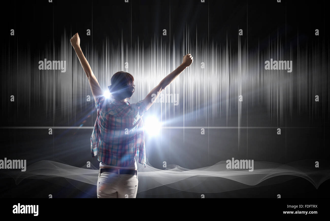 Back view of young girl in casual against dark background Stock Photo ...