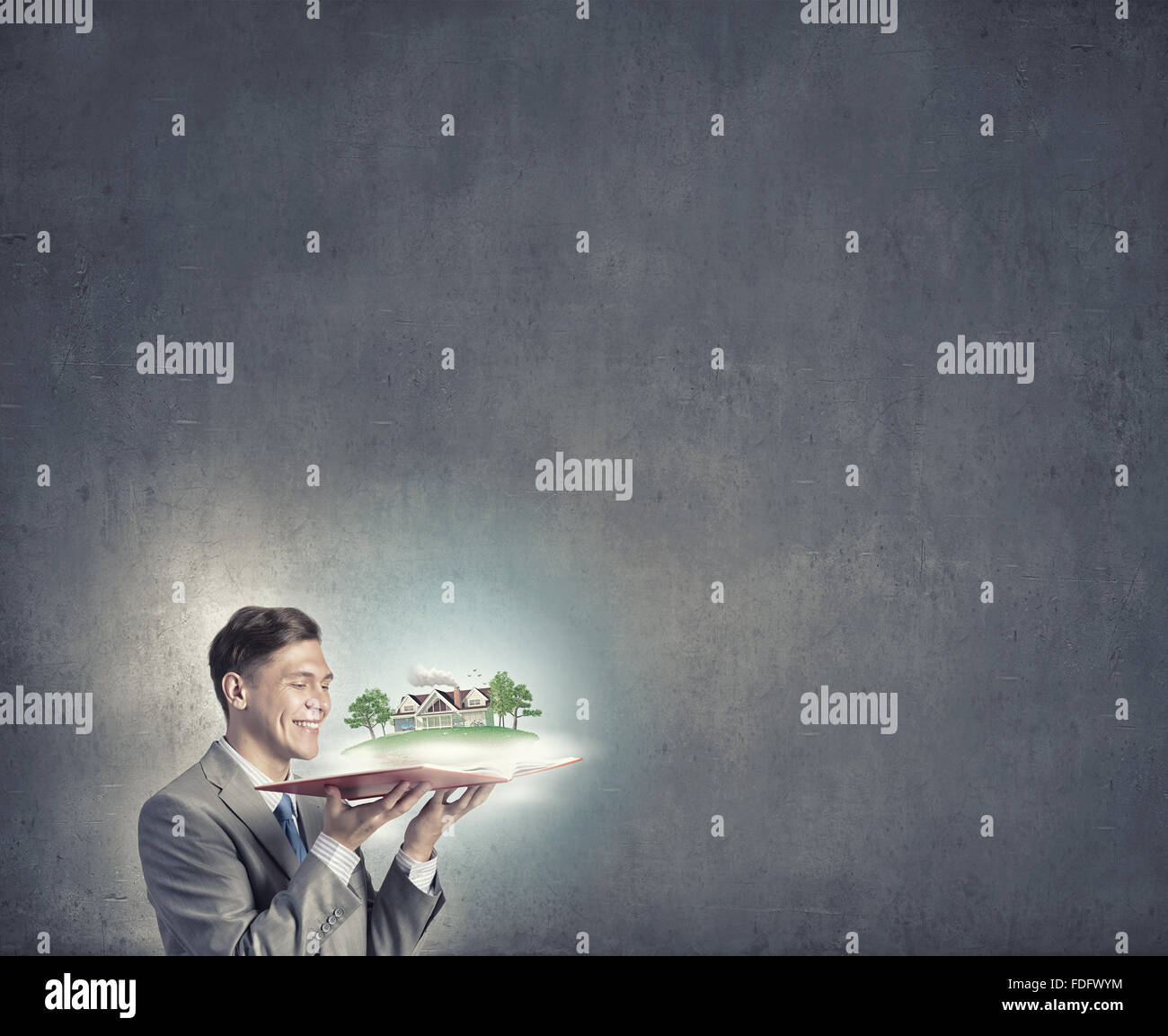 Businessman holding opened book with construction model on pages Stock ...