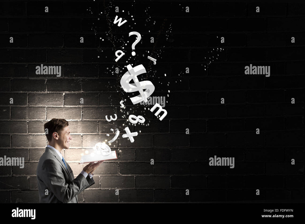 Businessman with book and dollar signs flying from pages Stock Photo ...