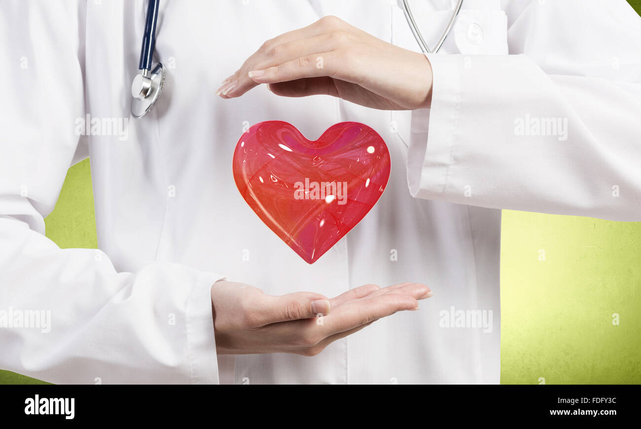 Close up of female doctor holding heart in hands Stock Photo - Alamy