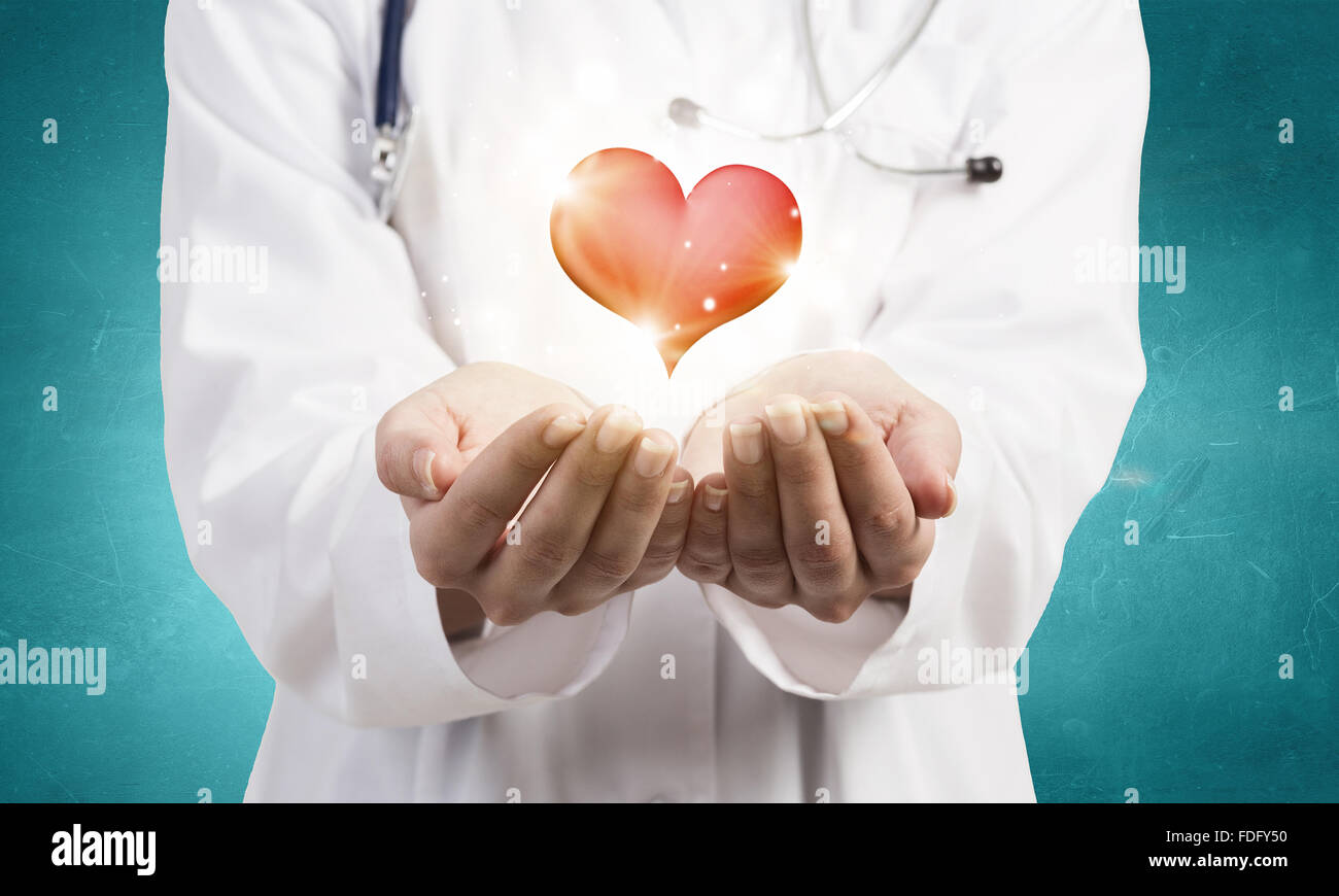 Close up of female doctor holding heart in hands Stock Photo - Alamy
