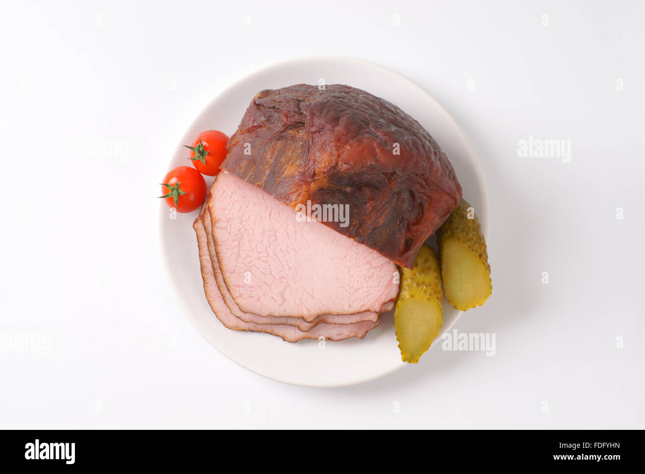 sliced chunk of roasted pork on white plate Stock Photo - Alamy