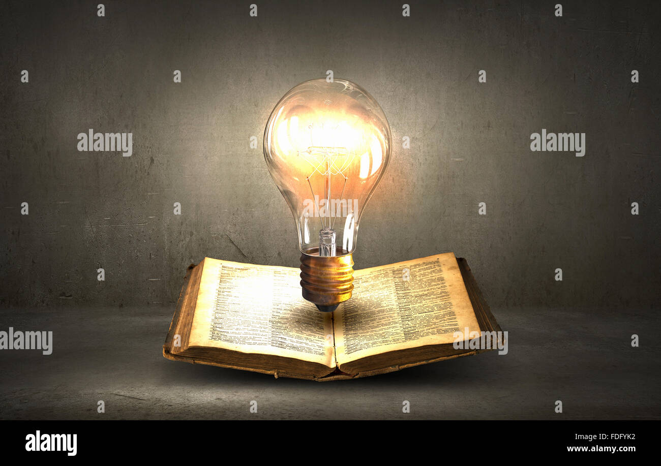 Glass glowing light bulb on opened book Stock Photo - Alamy
